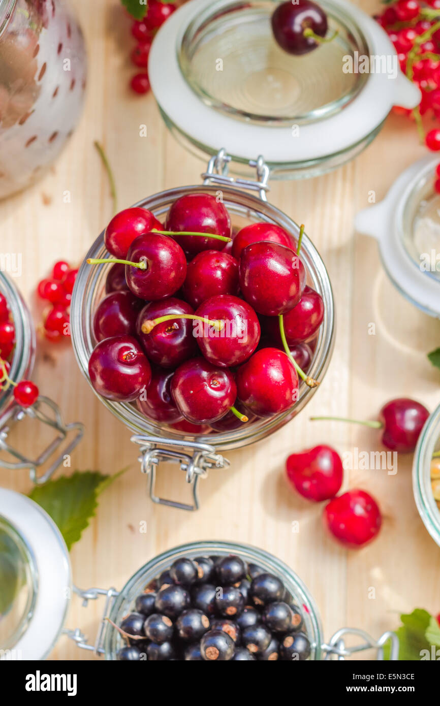 Preparation of products processed: fresh colorful summer fruits in jars ...