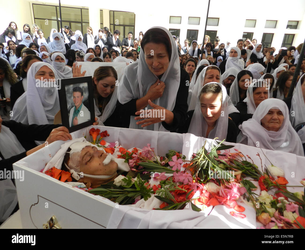 Beirut, Lebanon. 4th Aug, 2014. People attend funeral of a Lebanese ...