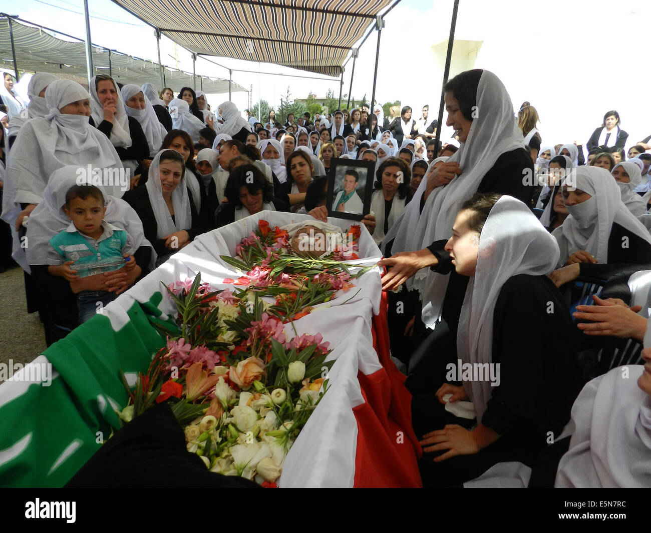 Beirut, Lebanon. 4th Aug, 2014. People attend funeral of a Lebanese ...