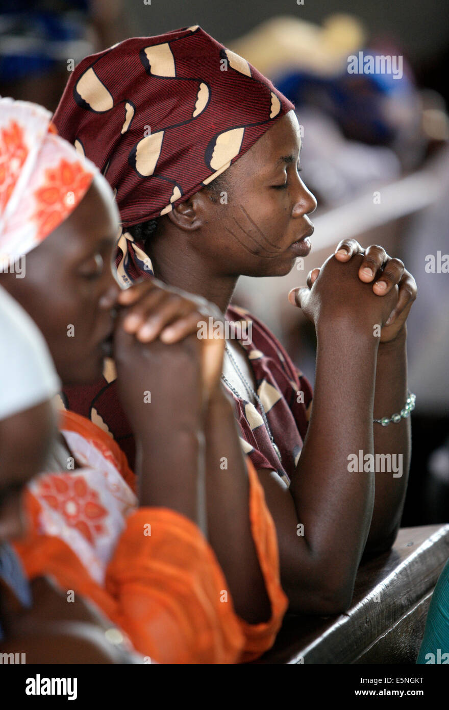 women praying during sunday service in a catholic church in Kuru ...