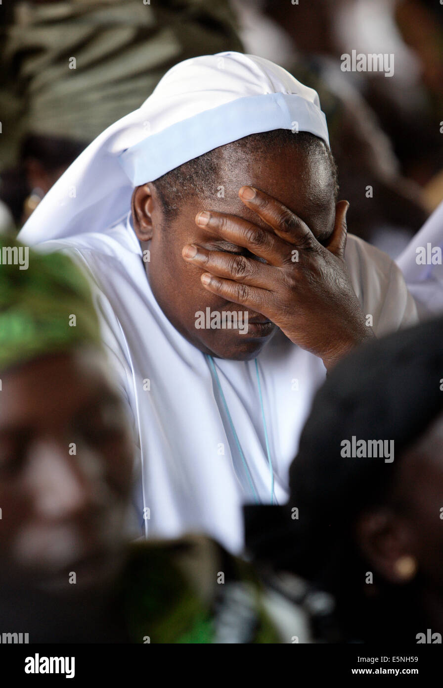 roman catholic nun (sister) praying during sunday service in a catholic ...