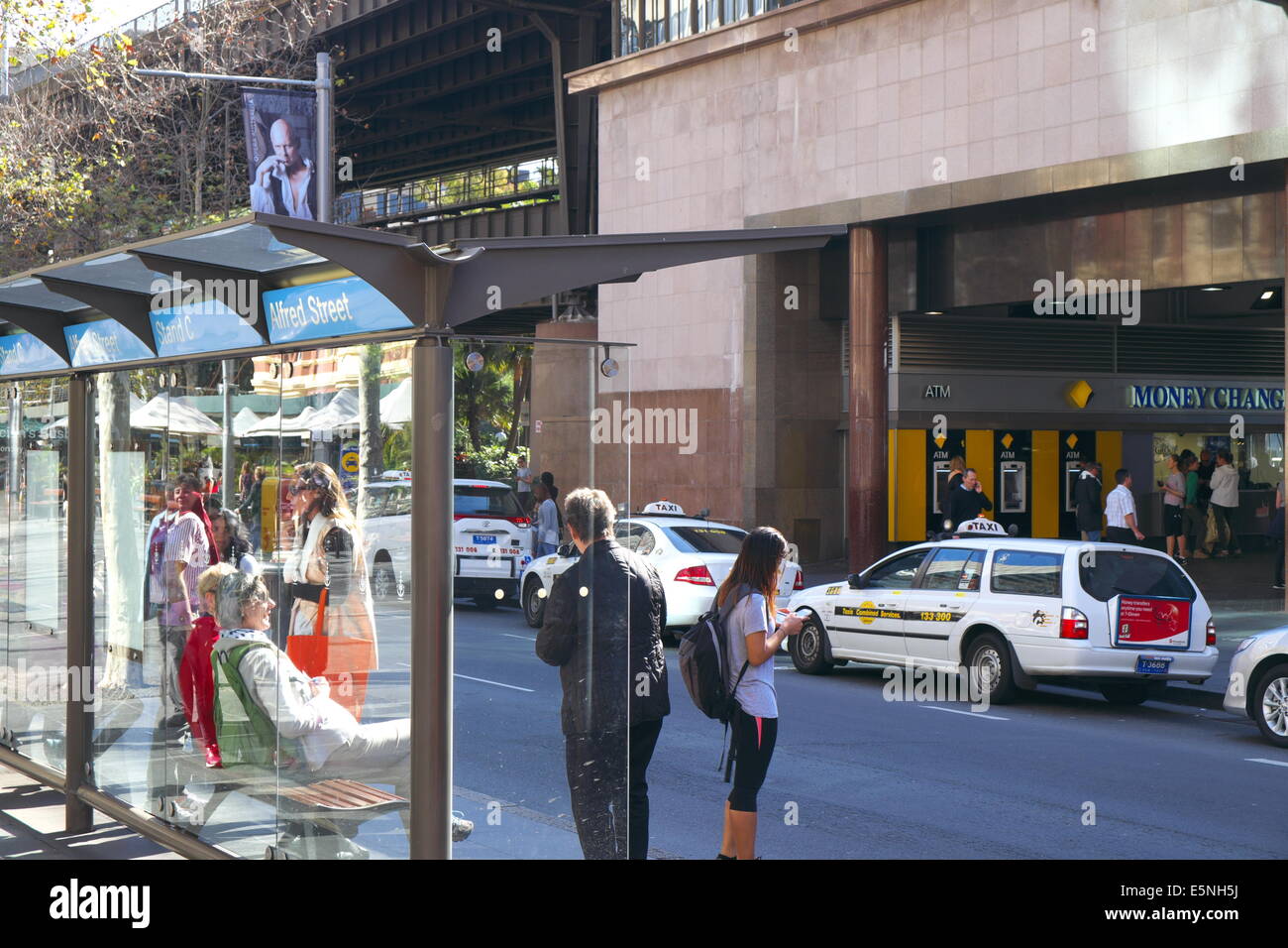 waiting for a bus to arrive at alfred street bus stop, circular quay ...