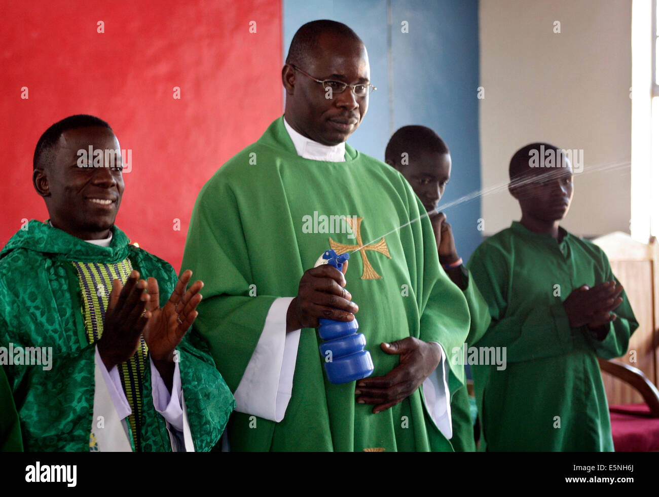 roman catholic priest spraying holy water on to the faithful during ...