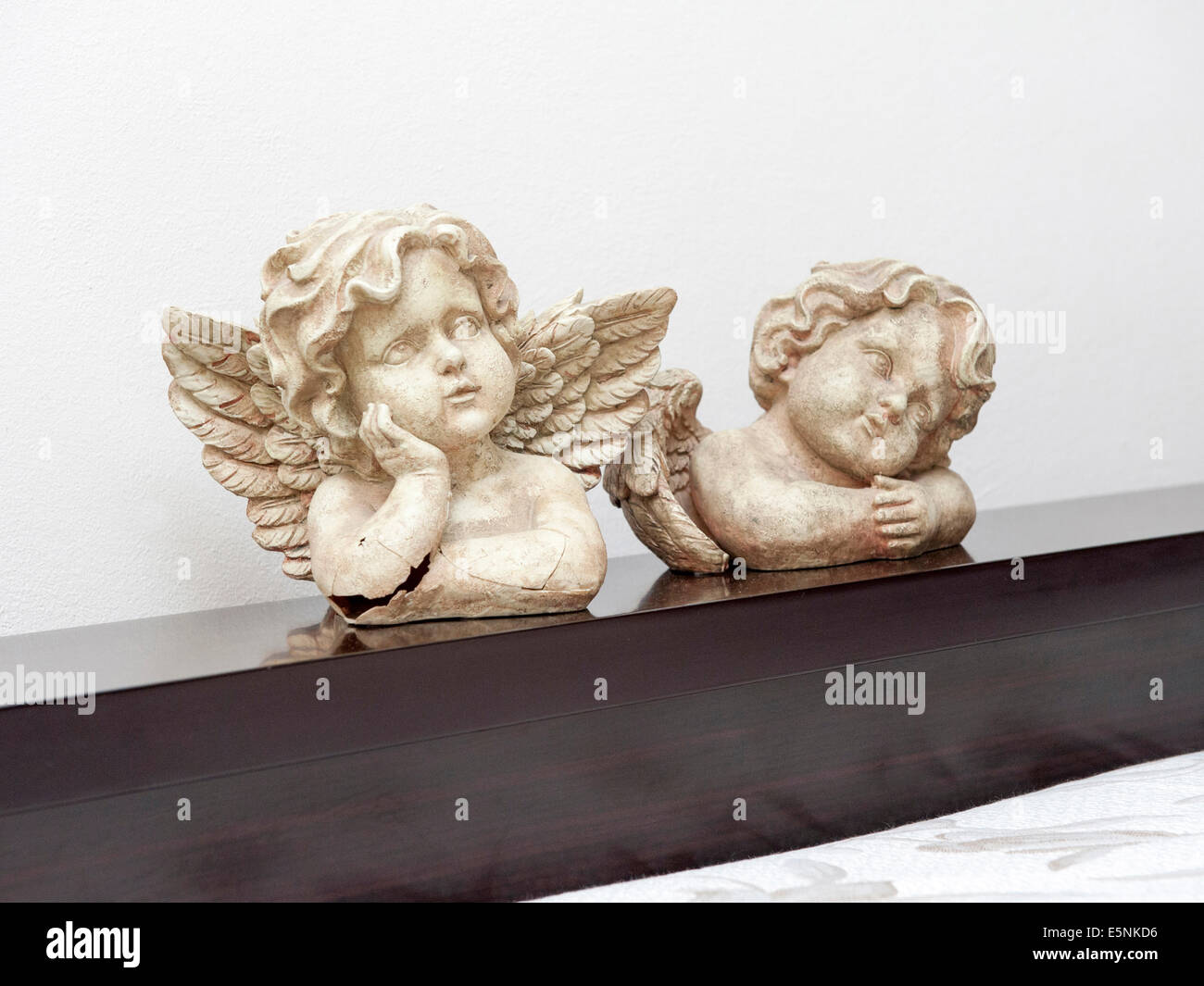 Little miniature statues of a white angels Stock Photo - Alamy