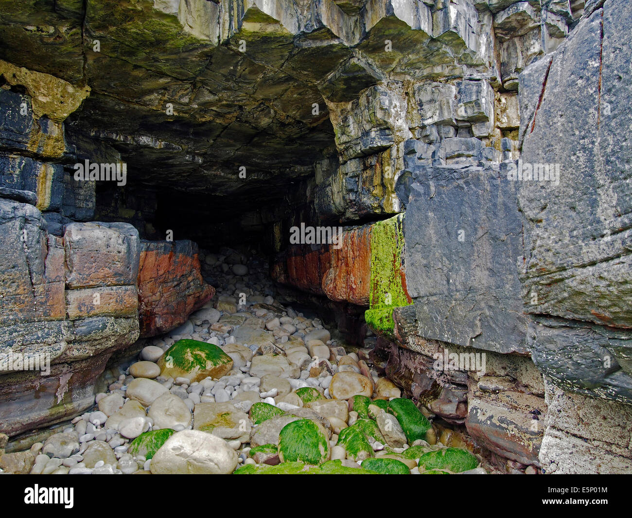 Sea cave cut into Mullaghmore sandstone strata in cliffs behind the ...