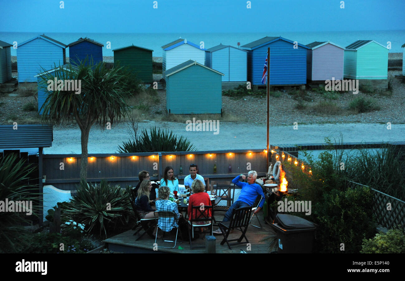 family enjoy summer weekend barbecue late Sunday night with chimenea ...