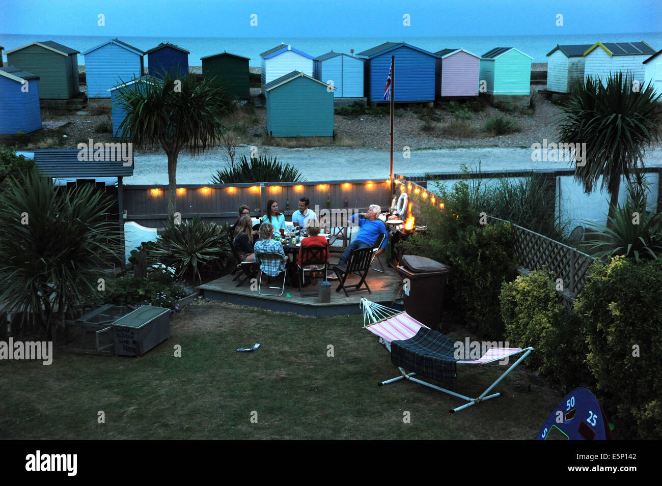 family enjoy summer weekend barbecue late Sunday night with chimenea ...