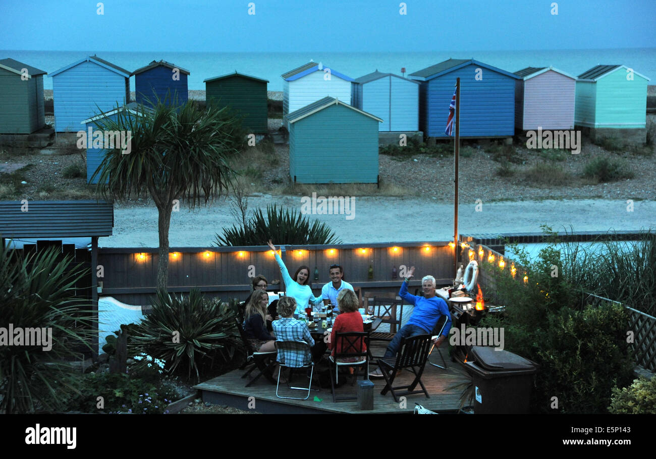 family enjoy summer weekend barbecue late Sunday night with chimenea ...