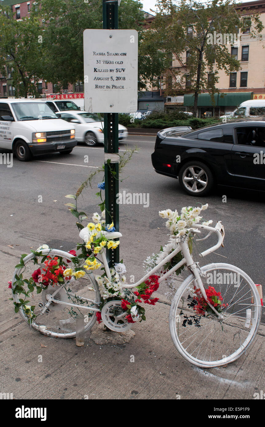 A bicycle painted white chained to a pole in memorial of a bicycle ...