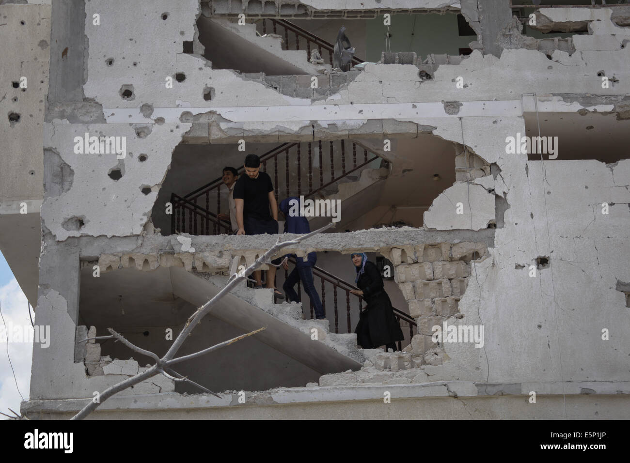 Gaza. 4th Aug, 2014. Palestinian inspects destroyed house in Beit ...