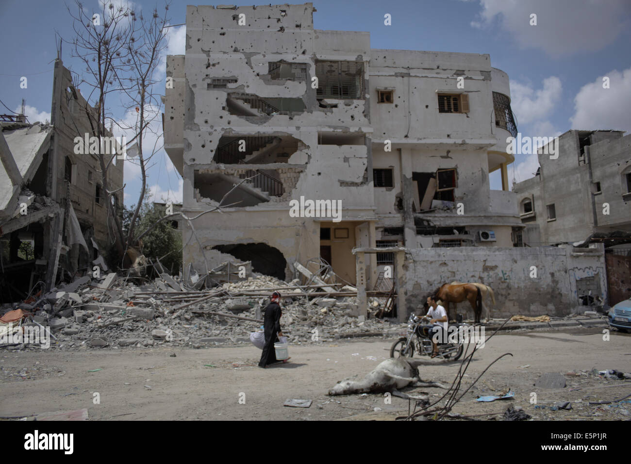 Gaza. 4th Aug, 2014. Palestinian inspects destroyed house in Beit ...