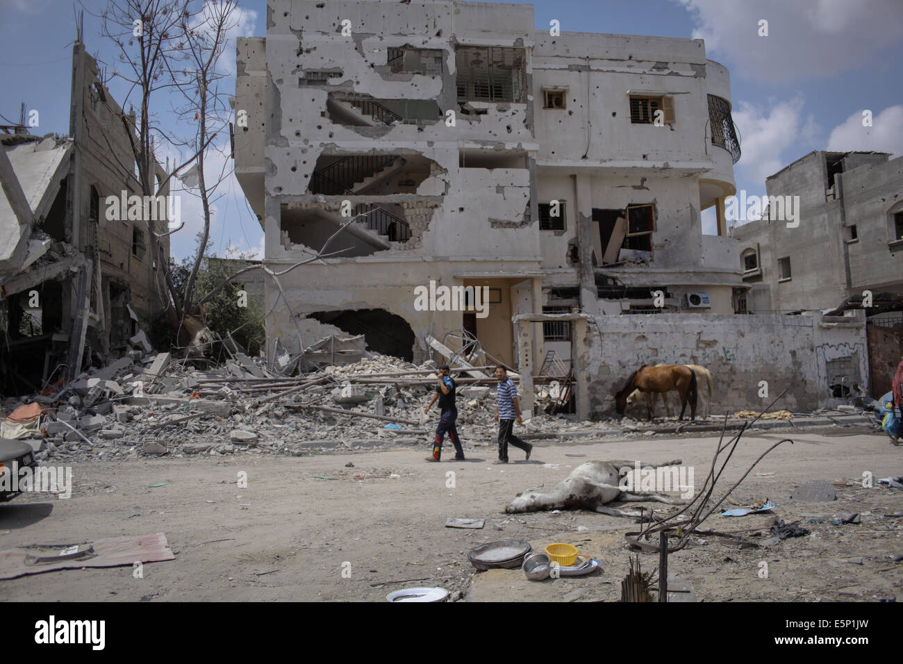 Gaza. 4th Aug, 2014. Palestinian inspects destroyed house in Beit ...