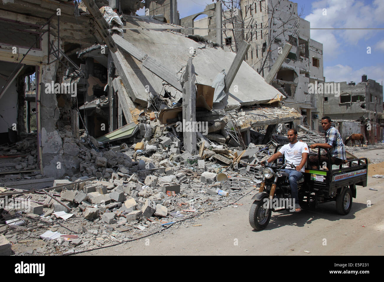 Gaza. 4th Aug, 2014. Palestinian man on the road around his destroyed ...