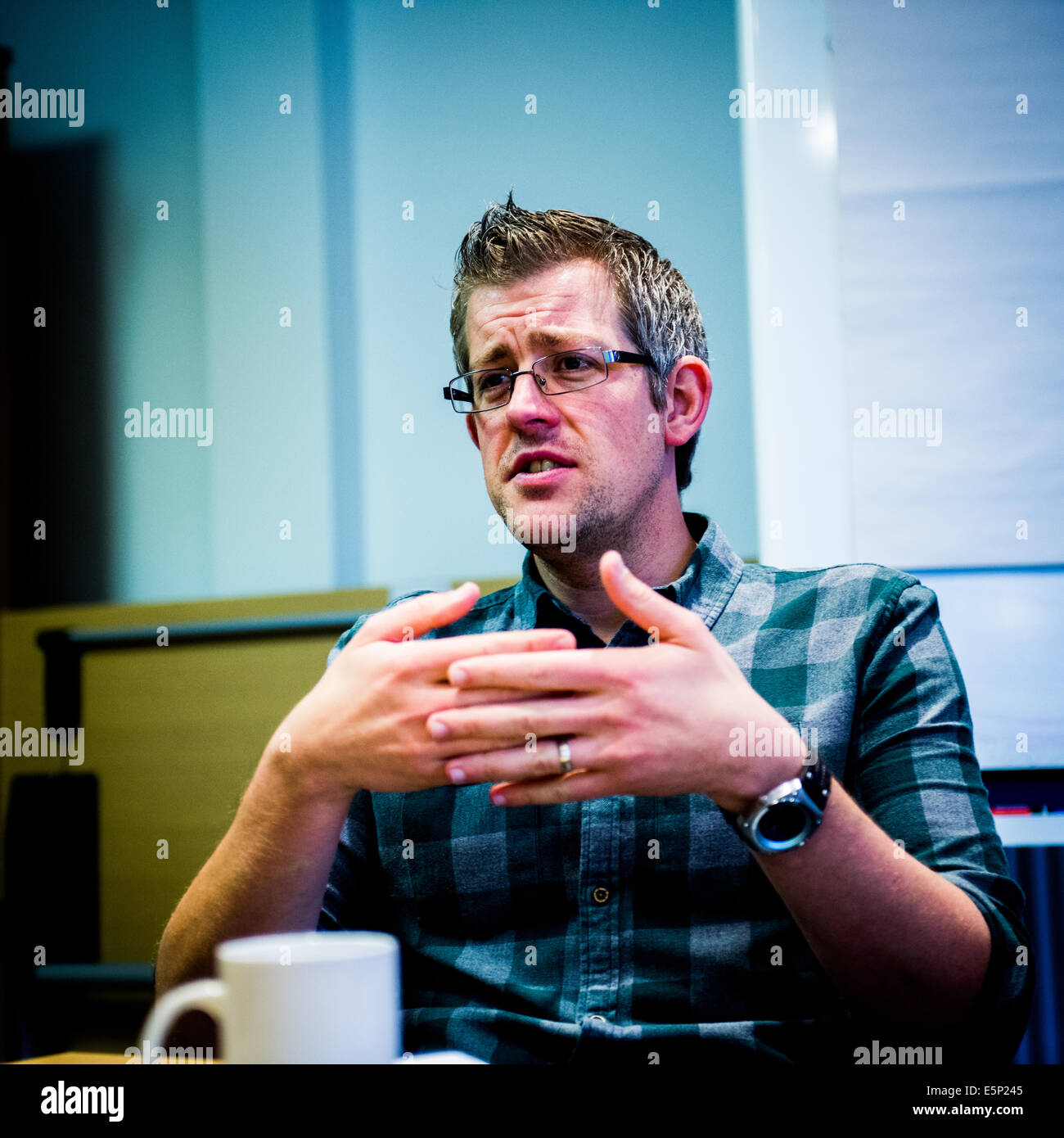 Office worker in meeting with cup of coffee Stock Photo - Alamy