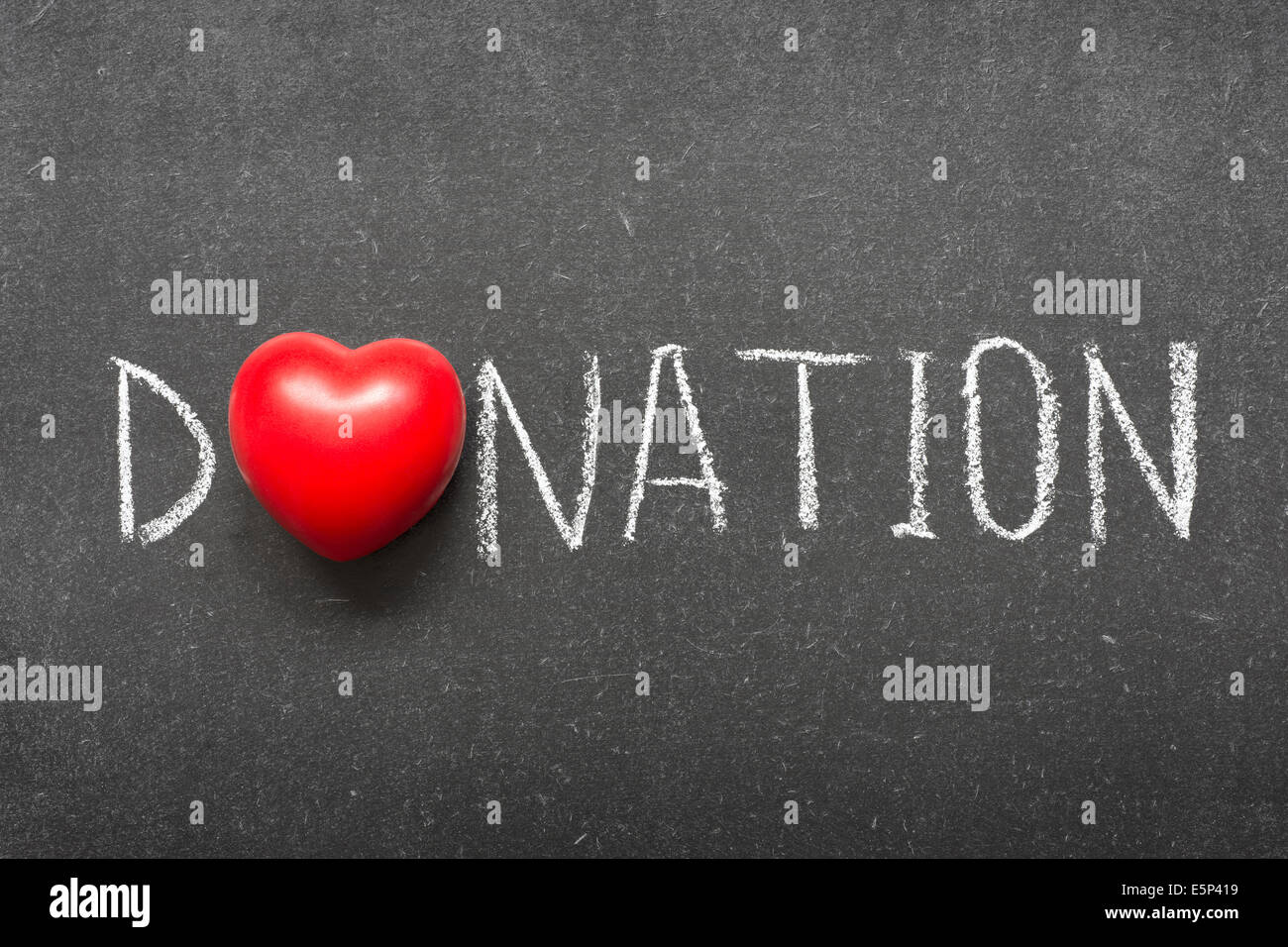 donation word handwritten on school blackboard with heart symbol ...