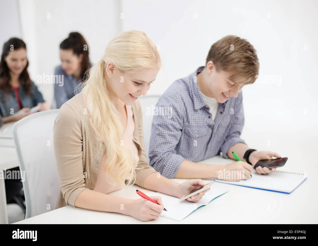 smiling students with notebooks at school Stock Photo - Alamy