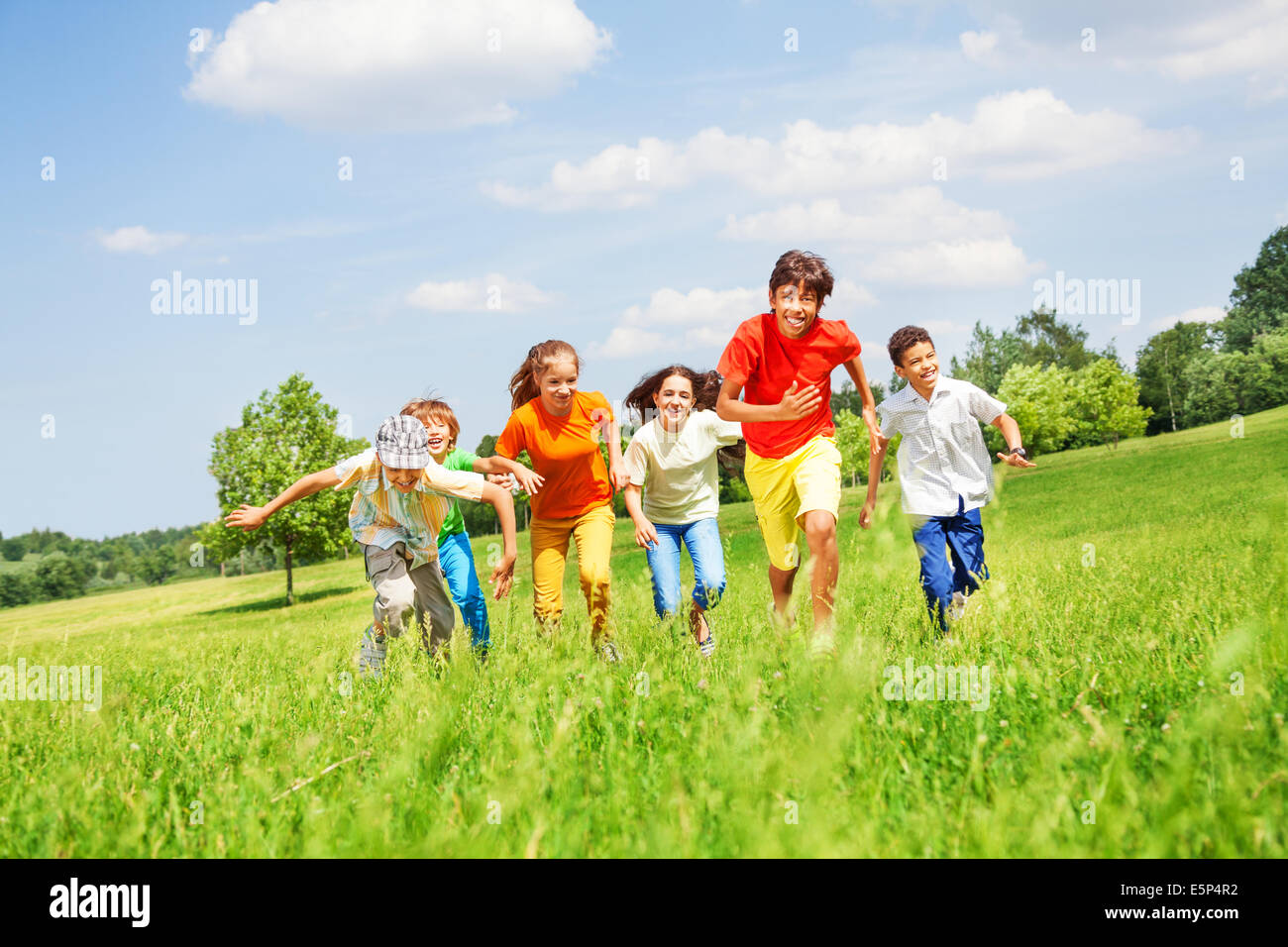 Funny children running in the field Stock Photo - Alamy