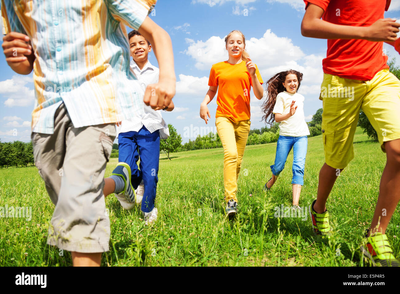 Running children together in motion outside Stock Photo - Alamy