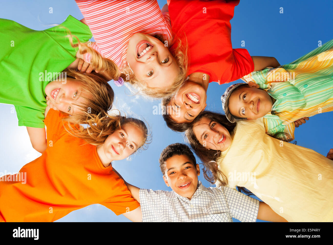 Happy kids close in circle on sky background Stock Photo - Alamy