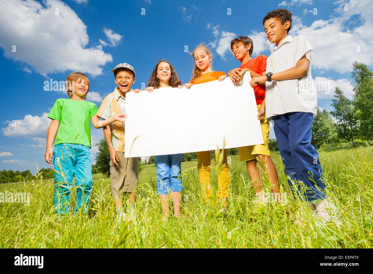 Children holding rectangular shape paper together Stock Photo - Alamy
