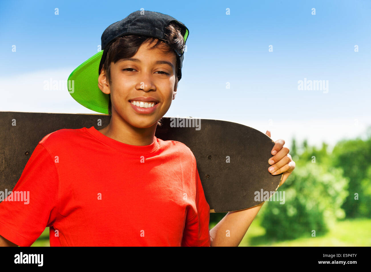 Cool boy in cap and with skateboard portrait Stock Photo - Alamy