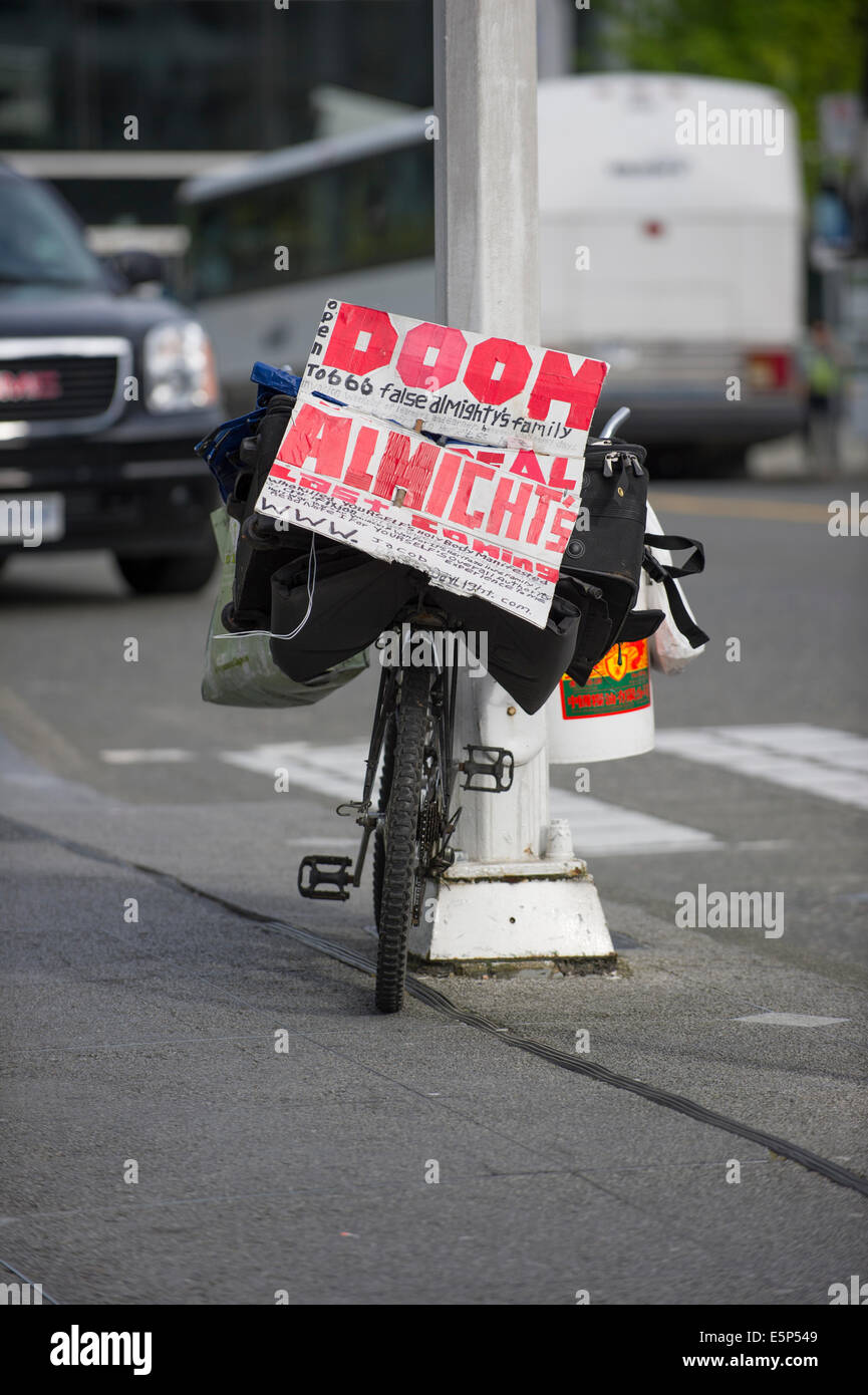 Bicycle with a doom and gloom signage attached to it Stock Photo - Alamy