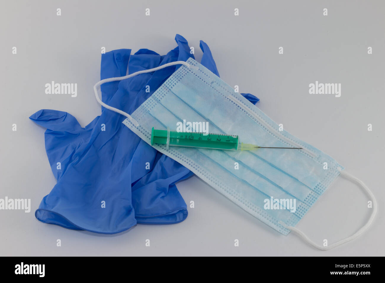 Protection against infection, mask, gloves and syringe on light ...