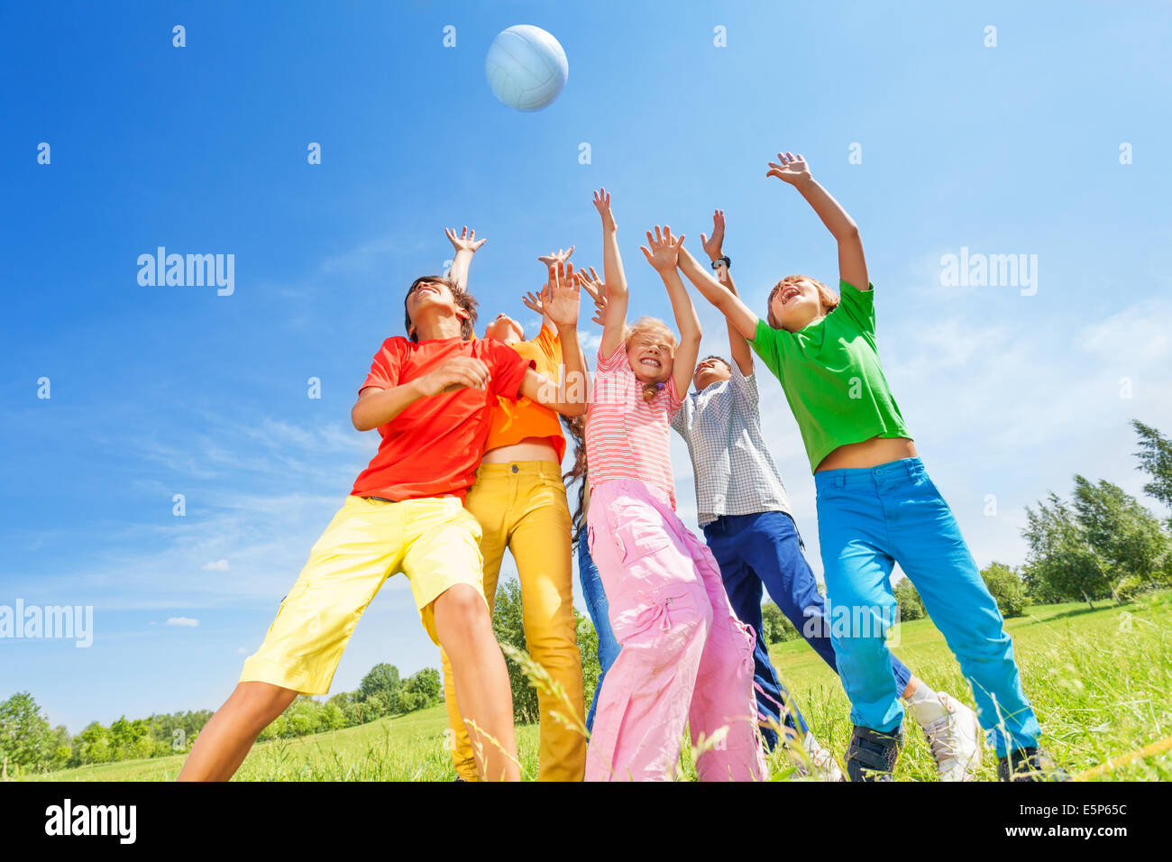 Happy children playing and catching ball Stock Photo - Alamy