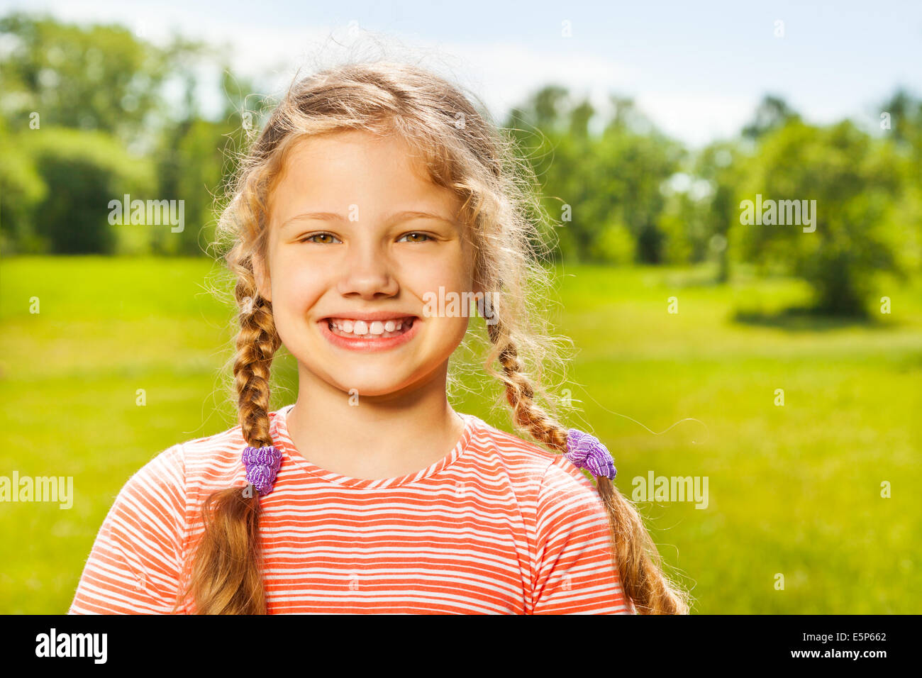 Portrait of happy girl with two braids in summer Stock Photo - Alamy