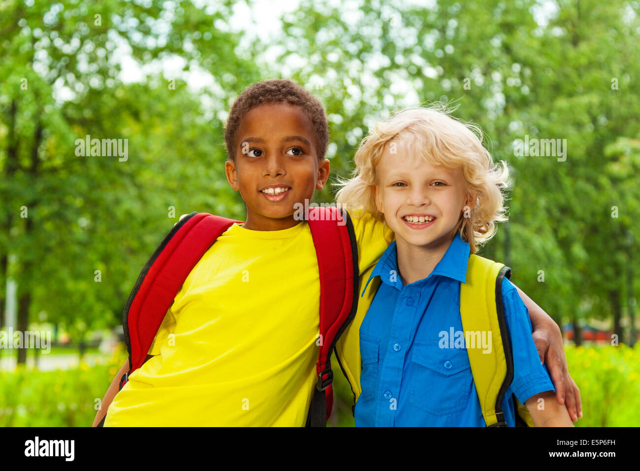 Two cute boys after school in a hug outside Stock Photo - Alamy