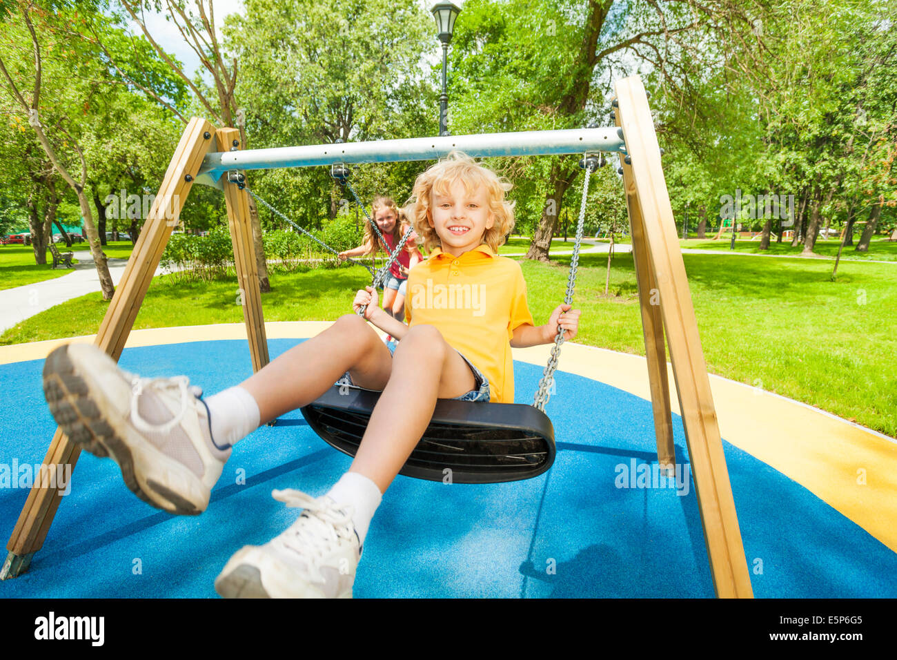 Boy and girl swing in opposite directions Stock Photo - Alamy