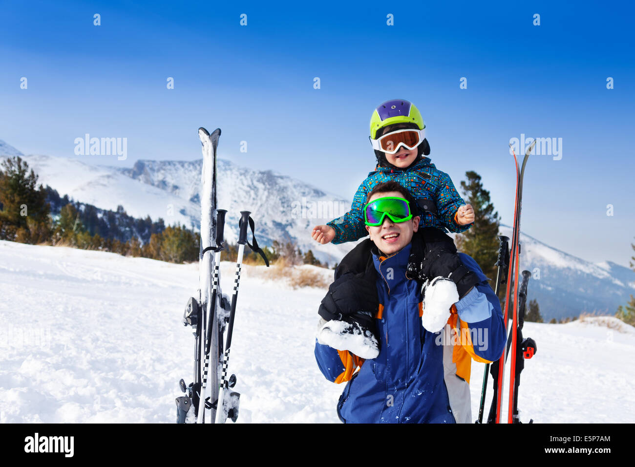 Happy father in ski mask with son on shoulders Stock Photo - Alamy