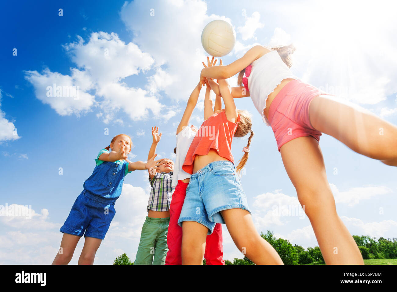 Group of children plays ball on a meadow Stock Photo - Alamy