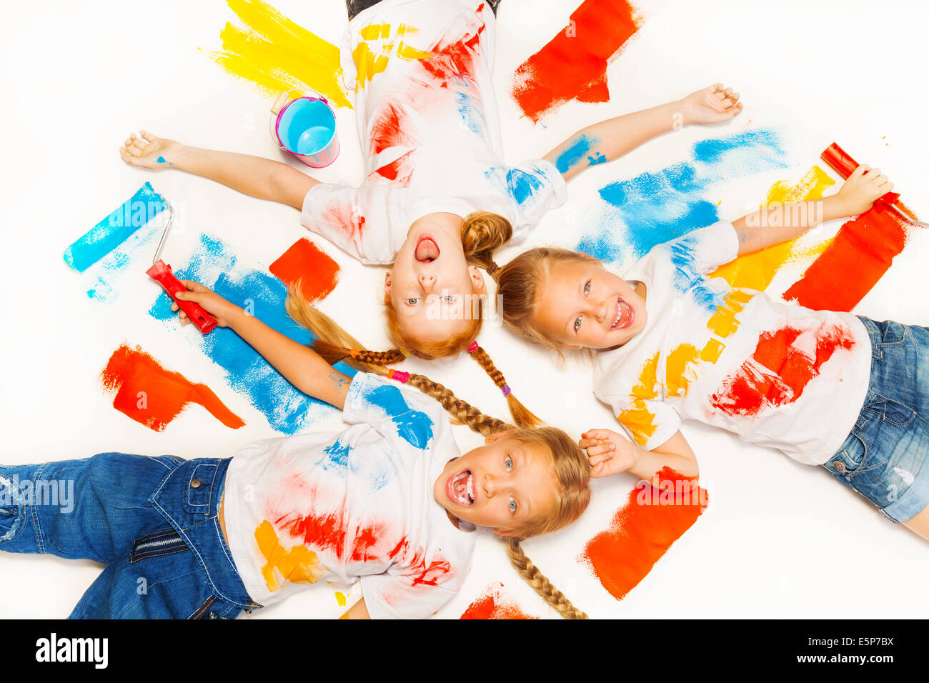 Three little kids lay on the floor and laugh Stock Photo - Alamy