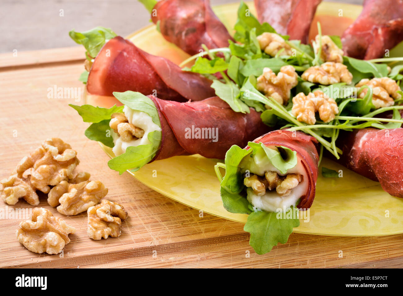 Appetizer with rosettes of cream bresaola with parmesan, rocket and ...