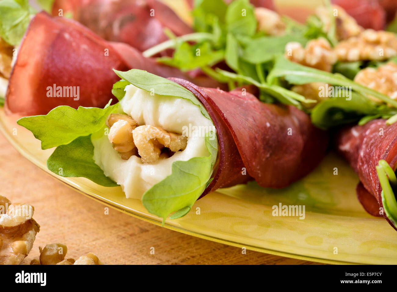 Appetizer with bresaola rosettes with parmesan cream, rocket and ...