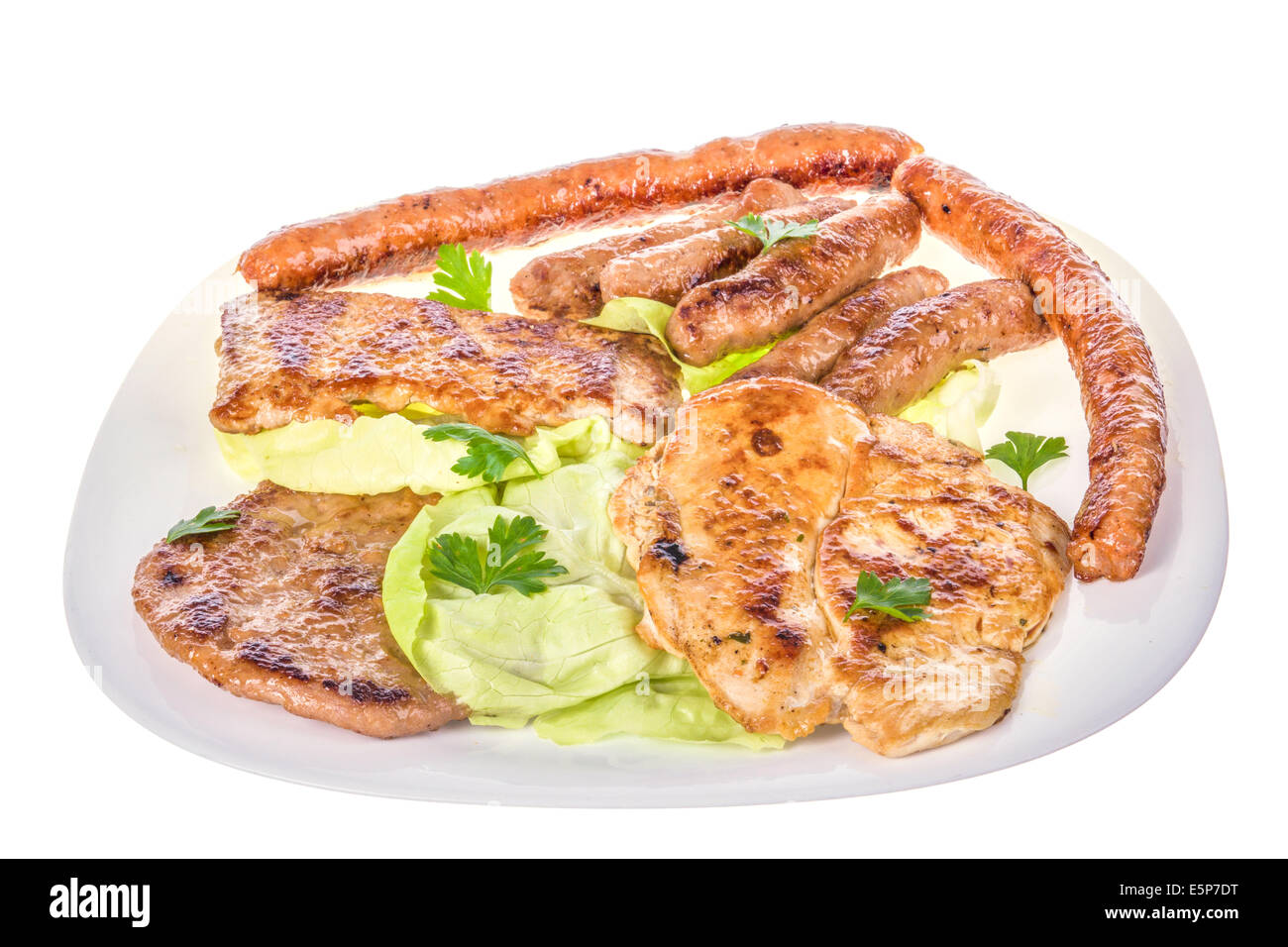 barbecue of various grilled meat on white plate closeup; barbecue with ...