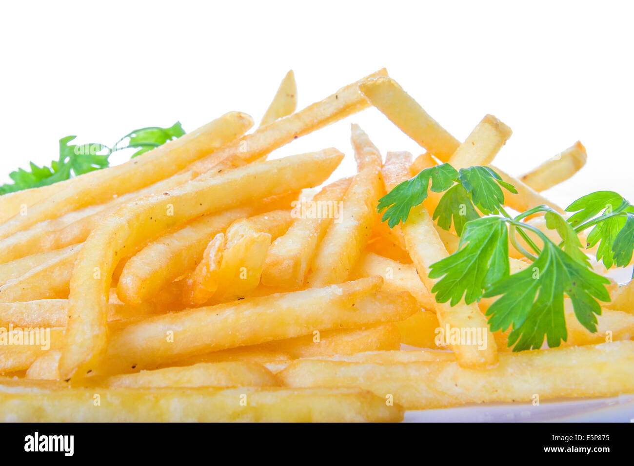 french fries in close up with parsley on top; crispy deep-fried golden ...