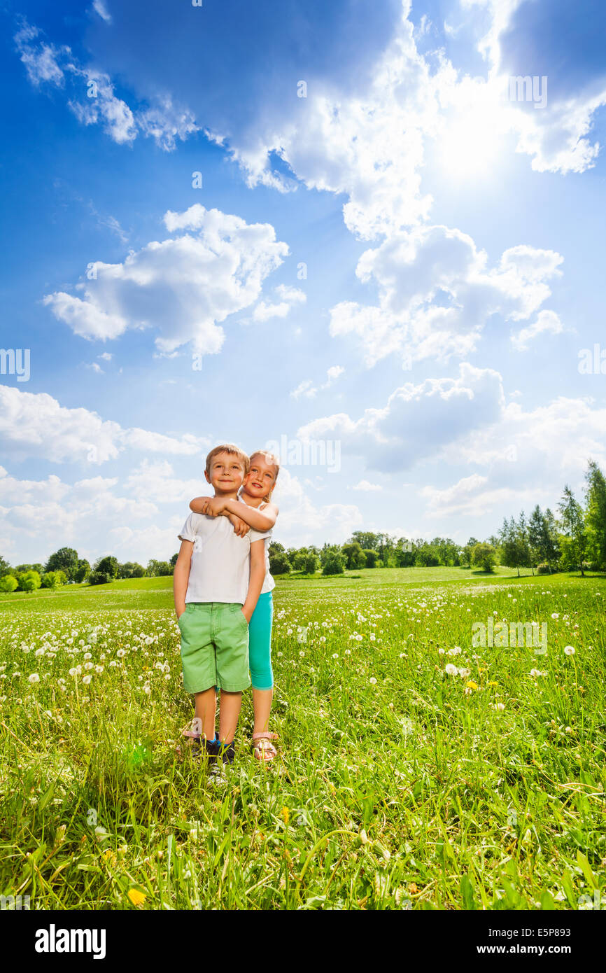 Two children stand together on a meadow Stock Photo - Alamy