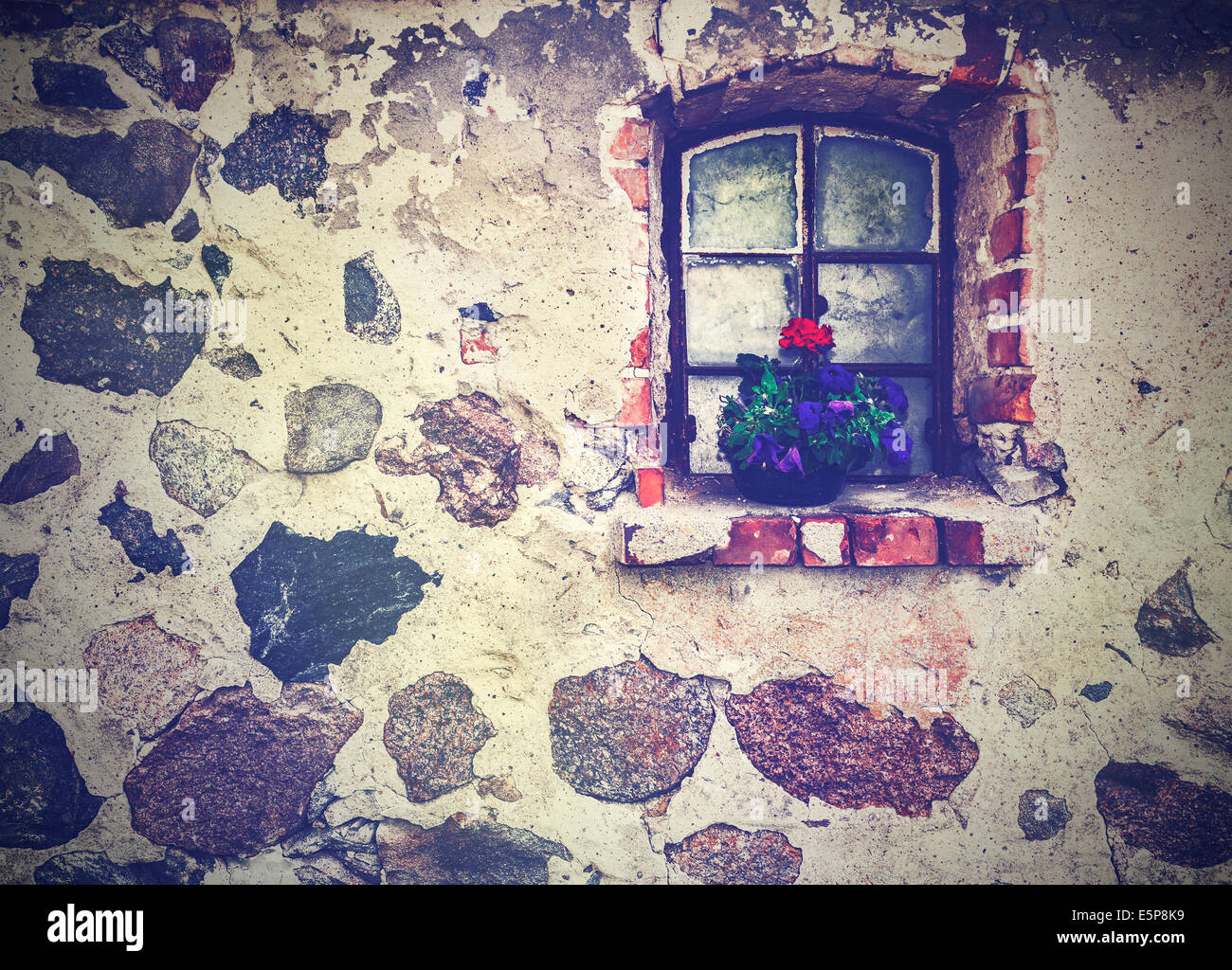 Vintage picture of flowers on the window, ancient building stone wall ...