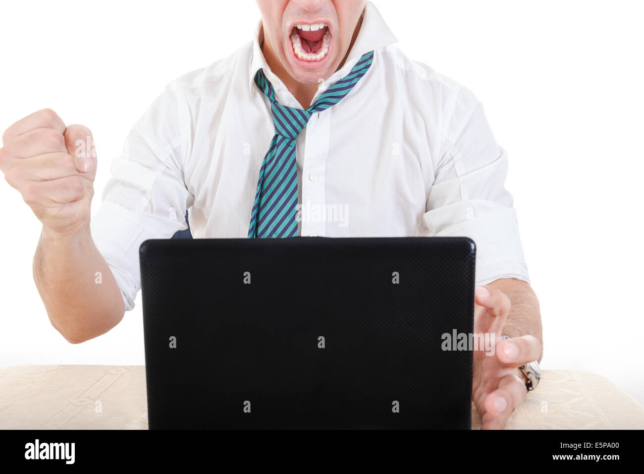 Angry anonymous businessman smashing his laptop on table with fist ...