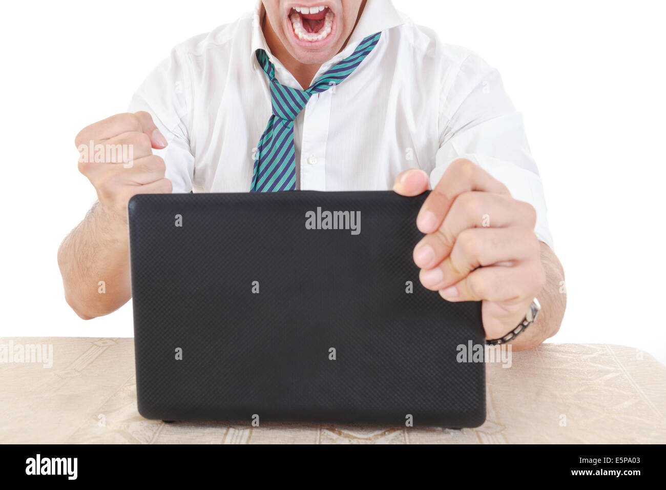 Furious anonymous young businessman ready to smash his laptop with fist ...