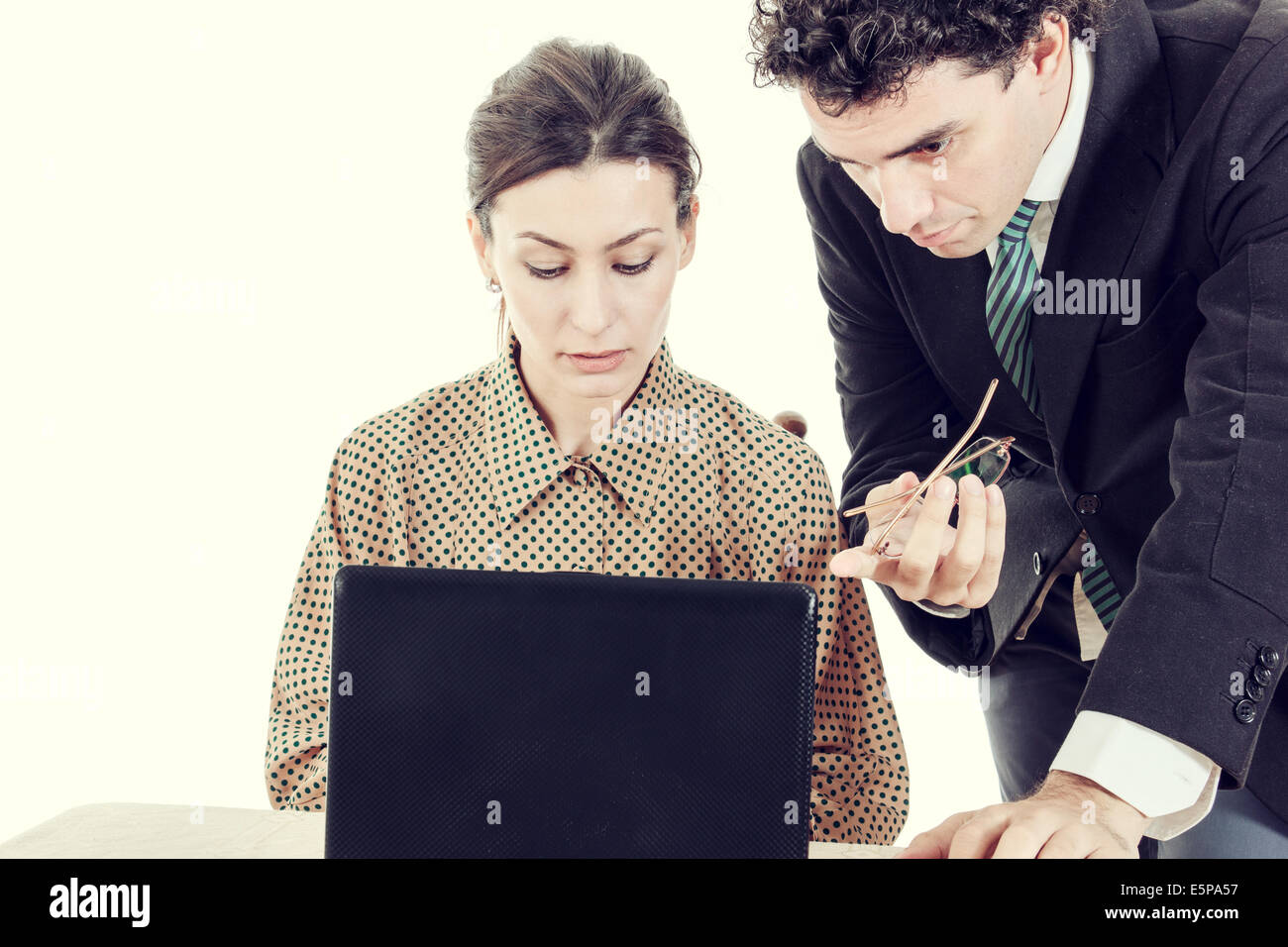 Boss and secretary working together on laptop computer, showing ...