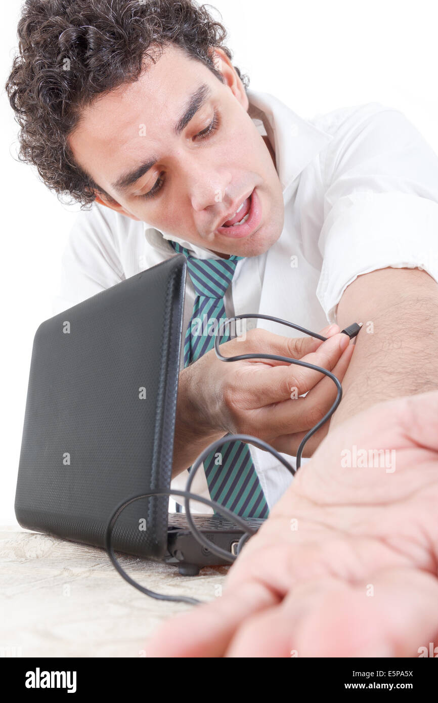 business man in suit addicted to internet put USB cable from laptop ...