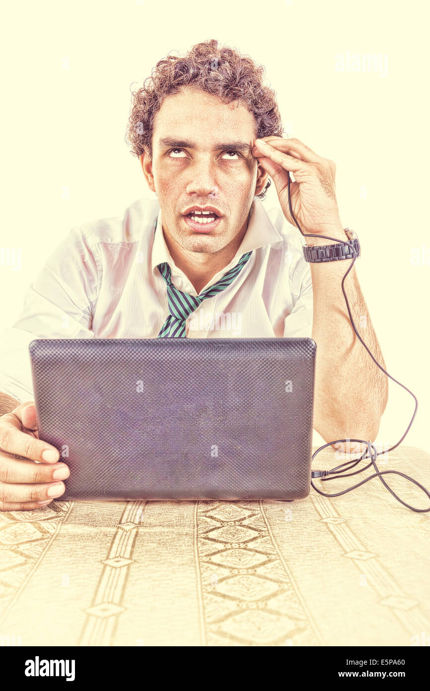 business man in suit addicted to internet put USB cable from laptop ...