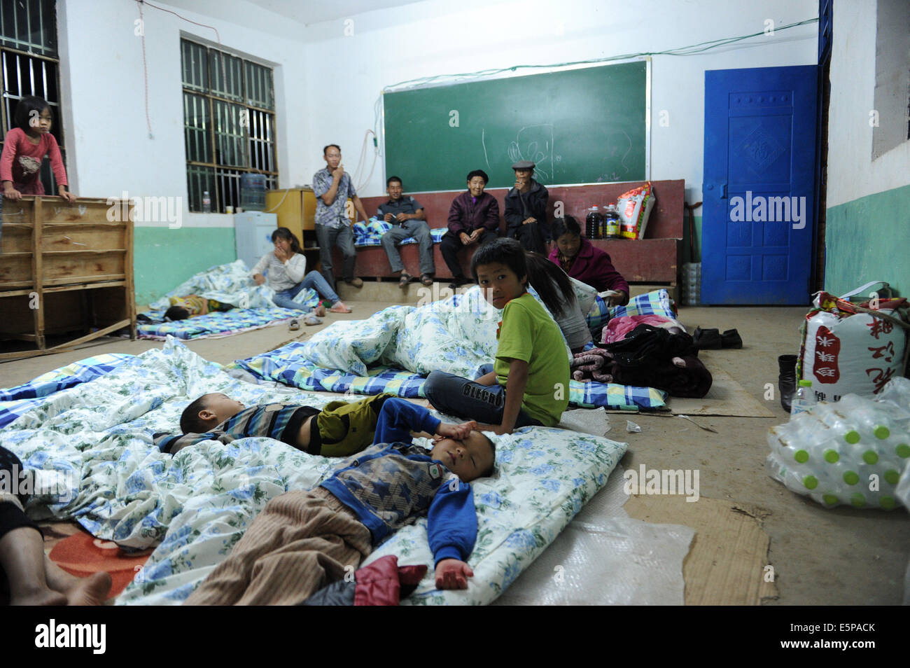 Weining, China's Guizhou Province. 4th Aug, 2014. Local residents rest ...