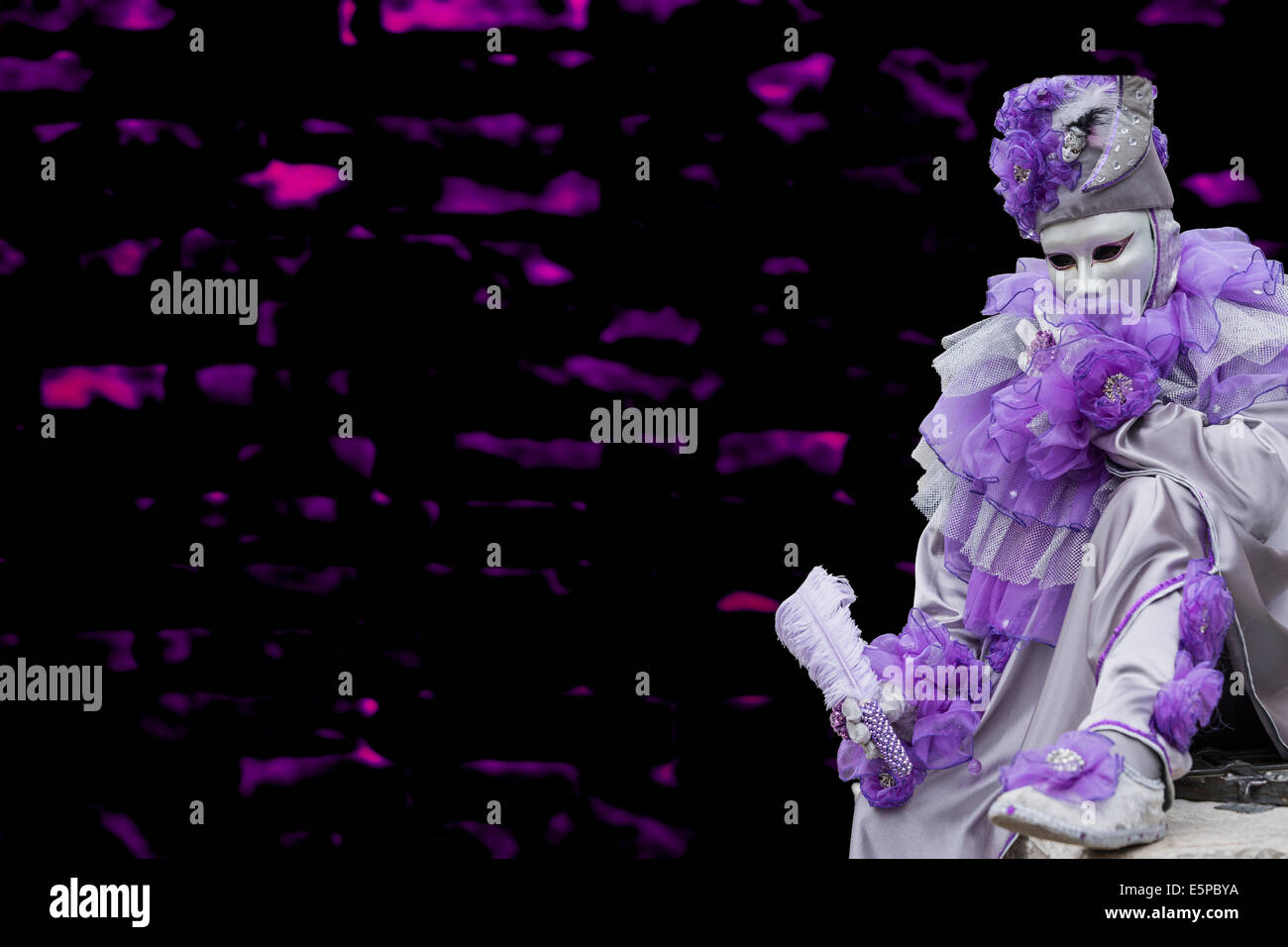 Thinking man in stylized purple & silver clown costume during Carnival ...