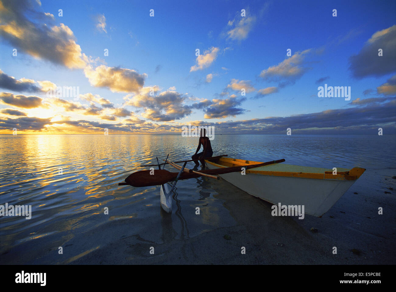 Person sitting on a canoe in Aitutaki, Cook Islands Stock Photo - Alamy