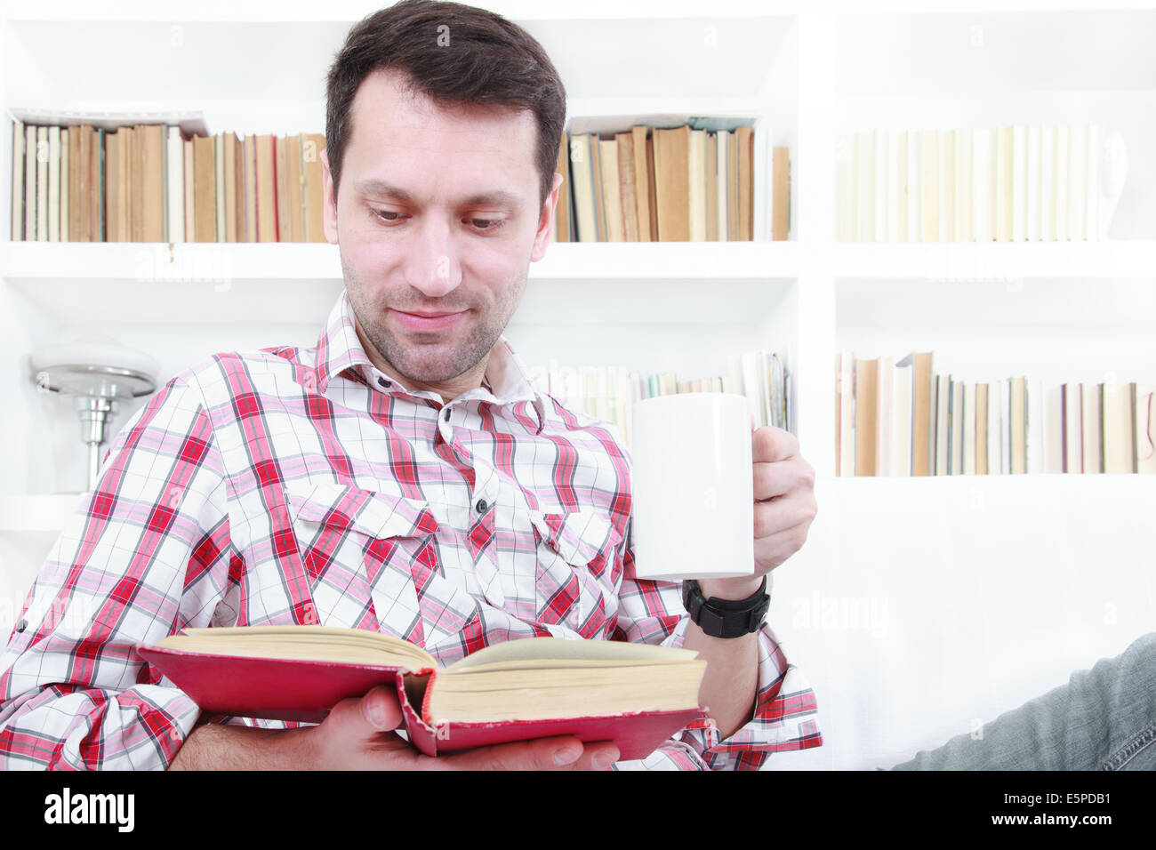 Interior with young man reading hi-res stock photography and images - Alamy