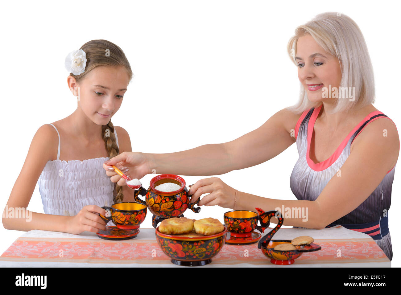 Mother and daughter drinking tea from painted tea things Stock Photo ...